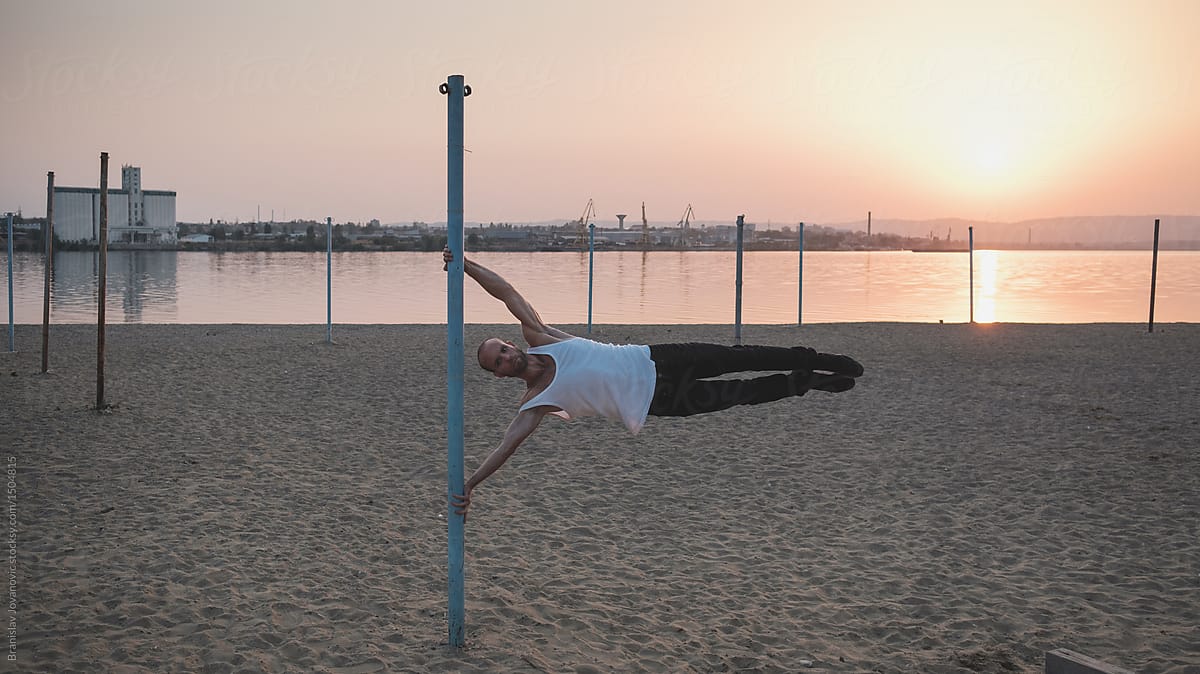 "Man Doing The "Flag" At The Beach" by Stocksy Contributor "B Krokodil ...