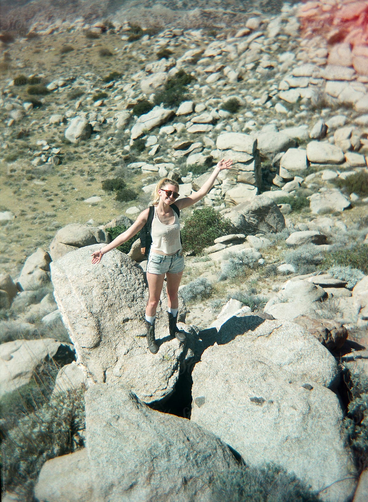 "Hiker Girl Standing On Pile Of Rocks With Arms Stretched Out" by ...