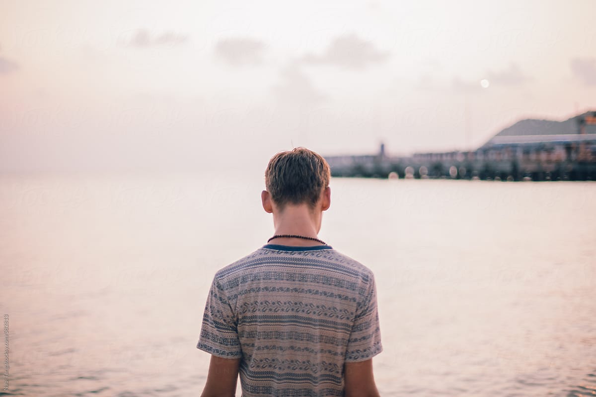 "Young Man Facing The Sea Alone In The Evening Sunset Time" by Stocksy ...