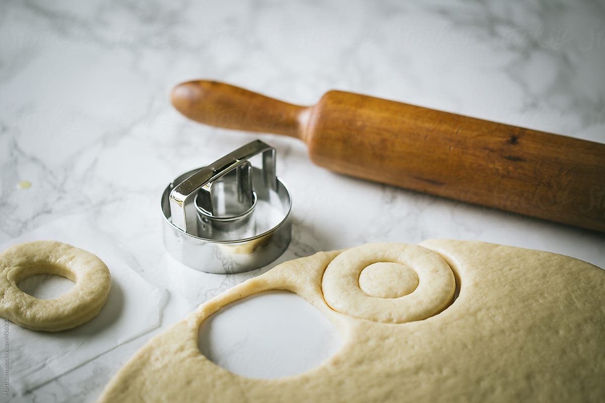 "Cutting Doughnuts" by Stocksy Contributor "Martí Sans" - Stocksy