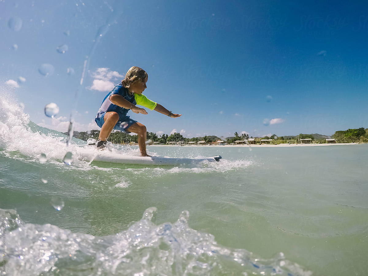 "Little Boy Surfing In Crystal Clear Water On Indonesia Island" by ...