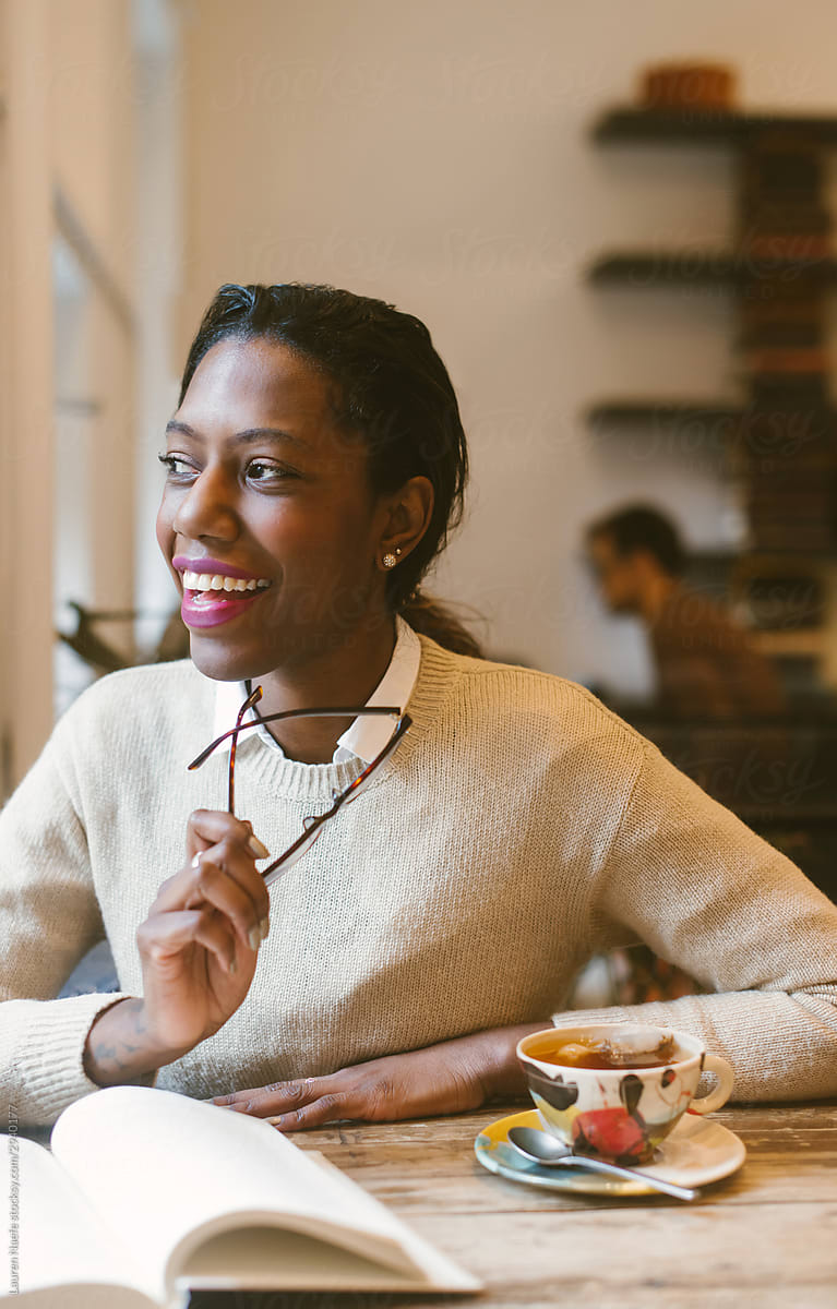 "Young Woman With Book At Coffee Shop" by Stocksy Contributor "Lauren ...