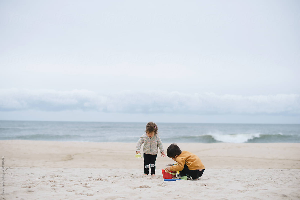 "Kids Playing On Beach In Cool Weather" by Stocksy Contributor "Lauren ...