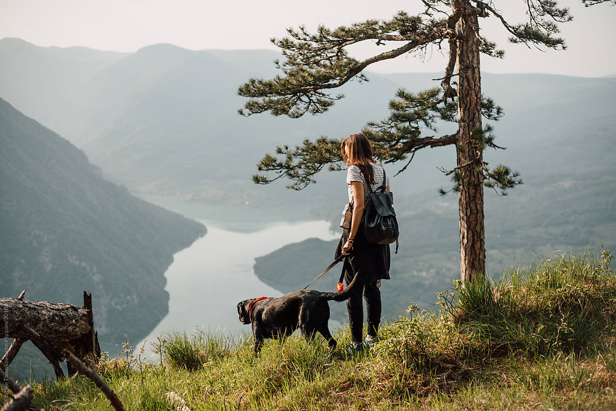 "Woman And Dog In Nature" by Stocksy Contributor "Dimitrije Tanaskovic ...