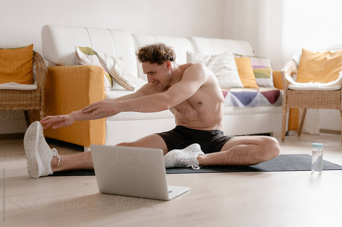 "Shirtless Man Doing Exercises During Online Training" by Stocksy ...