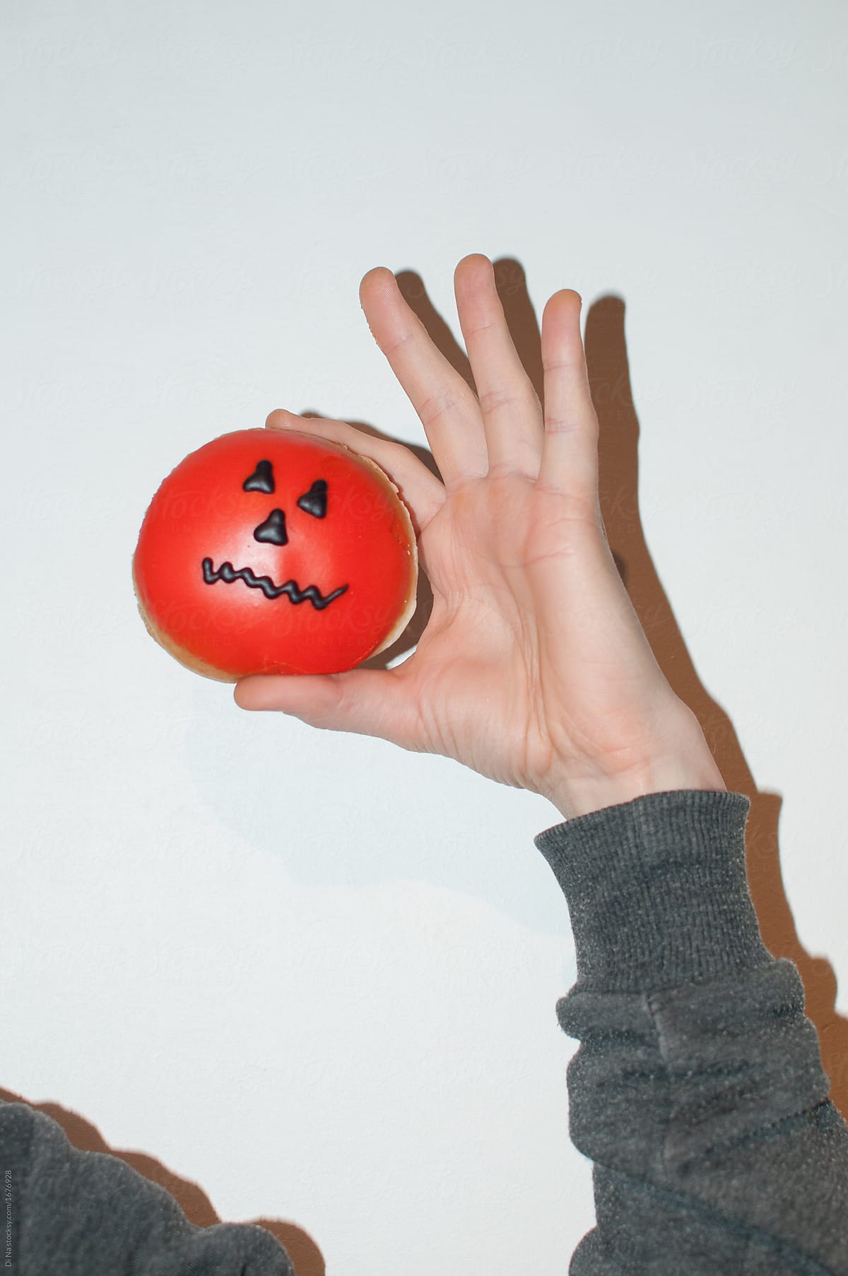 "Hand With A Halloween Donut" by Stocksy Contributor "Synchro Shoot ...