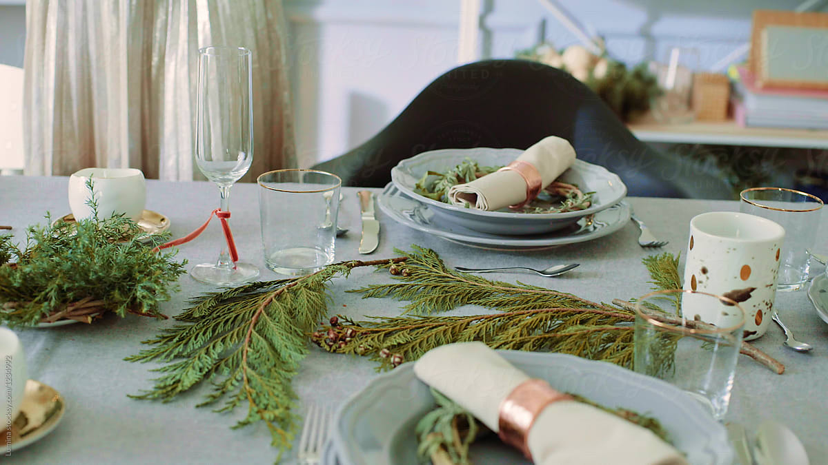 "Woman Setting Up Table For Christmas Dinner Party" by Stocksy ...