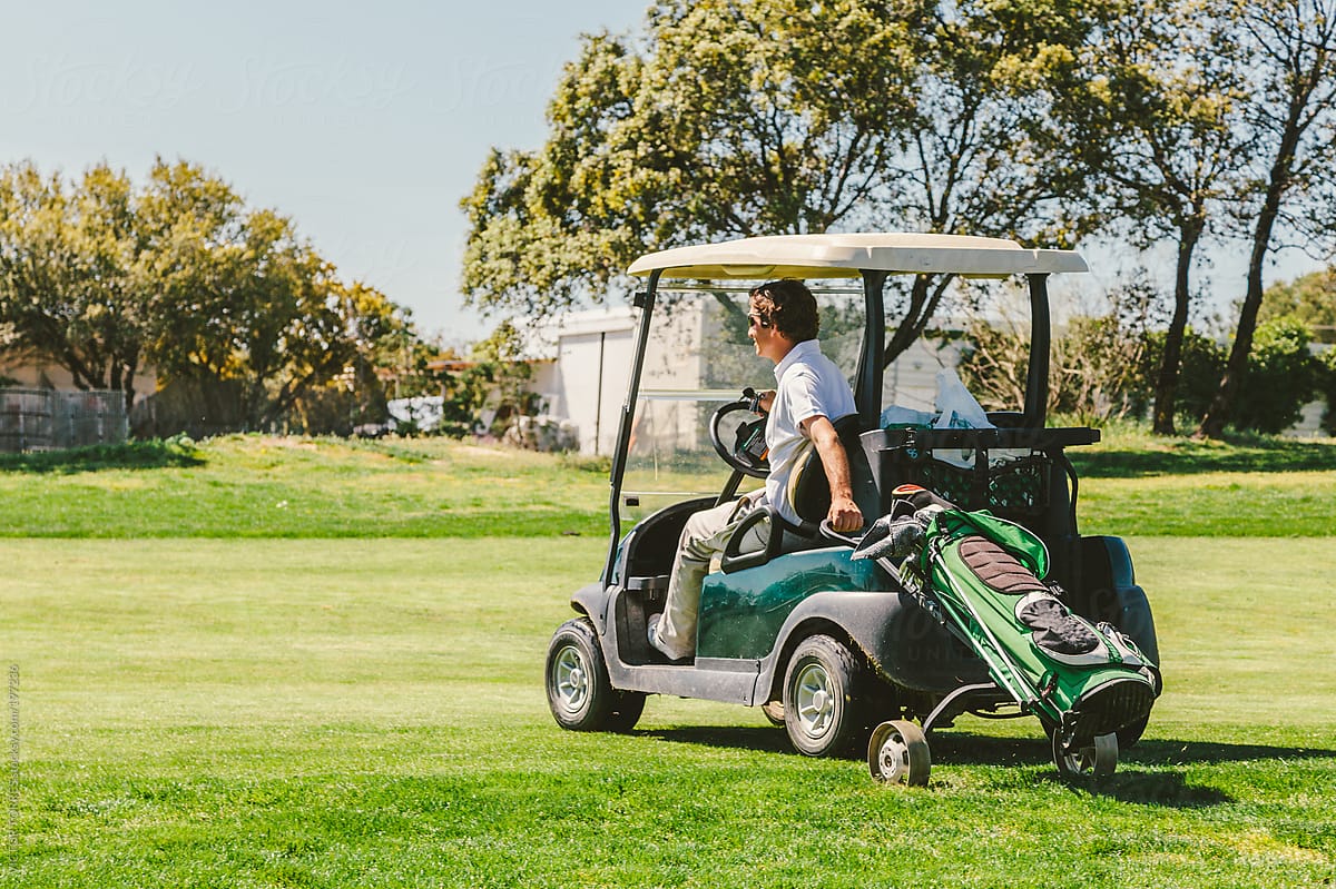 "Golfer Driving A Golf Cart" by Stocksy Contributor "VICTOR TORRES ...