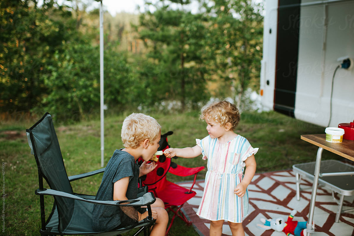 "Two Young Kids Sharing Their Ice Cream During Camping" by Stocksy ...