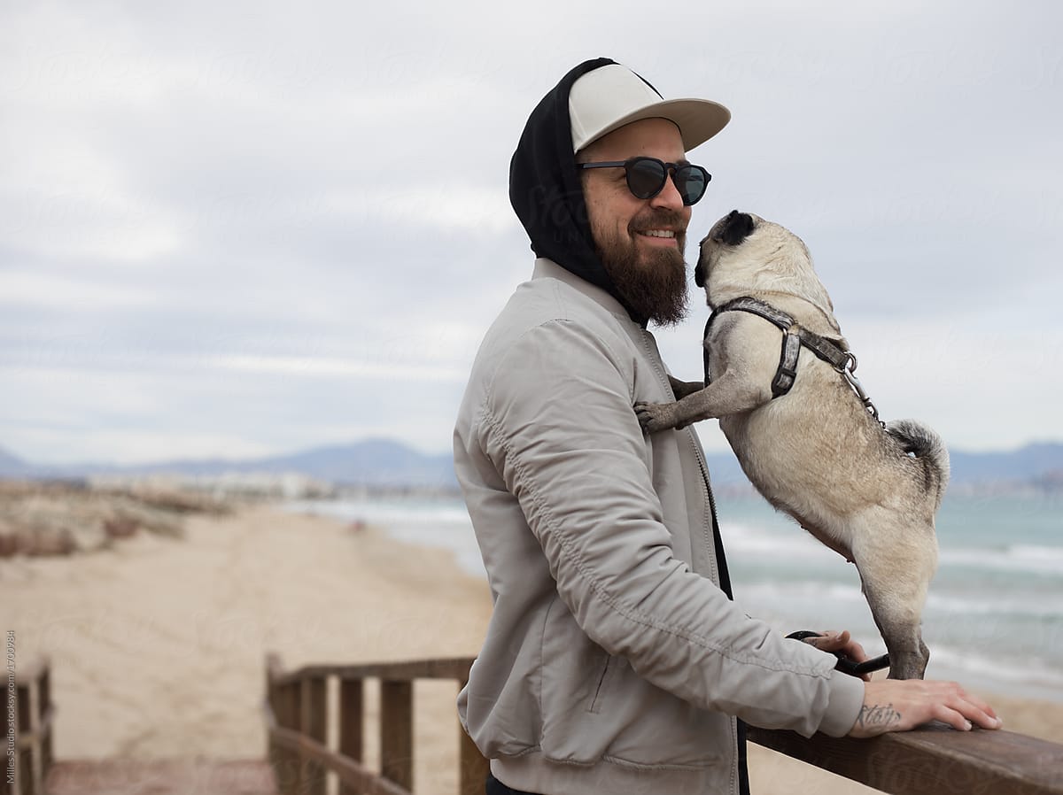 "Cheerful Man With Pug dog" by Stocksy Contributor "Milles Team" - Stocksy