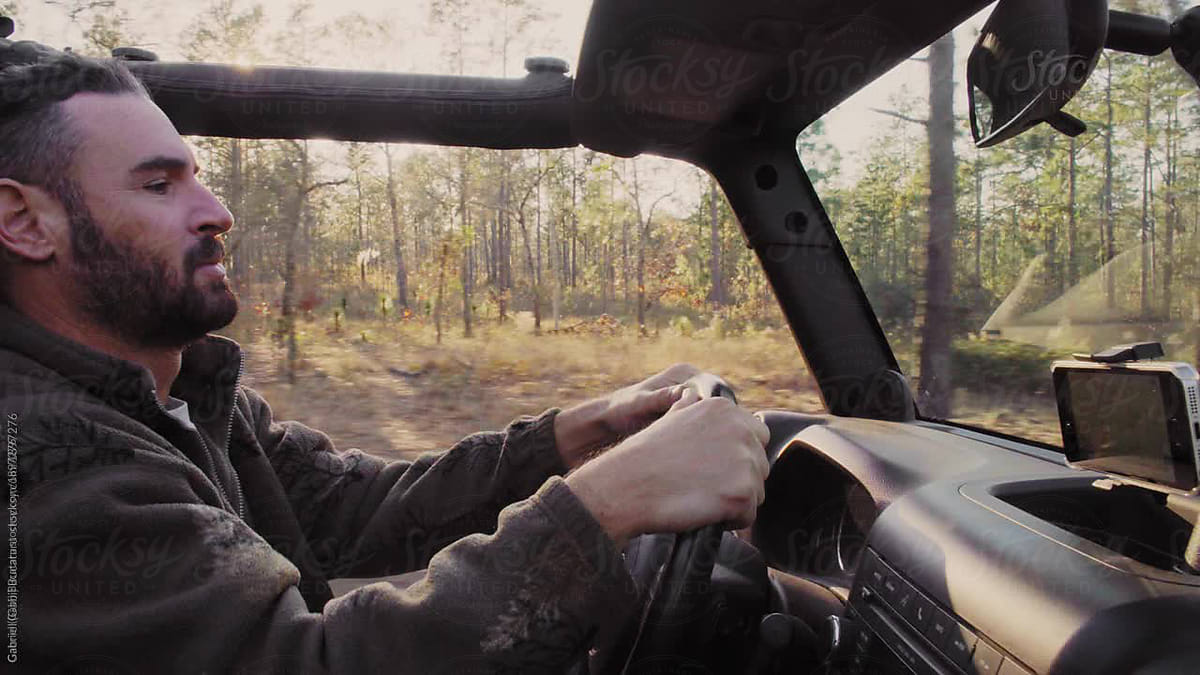 "Man Driving An Off-road Vehicle Through A Forest At Sunset" by Stocksy ...