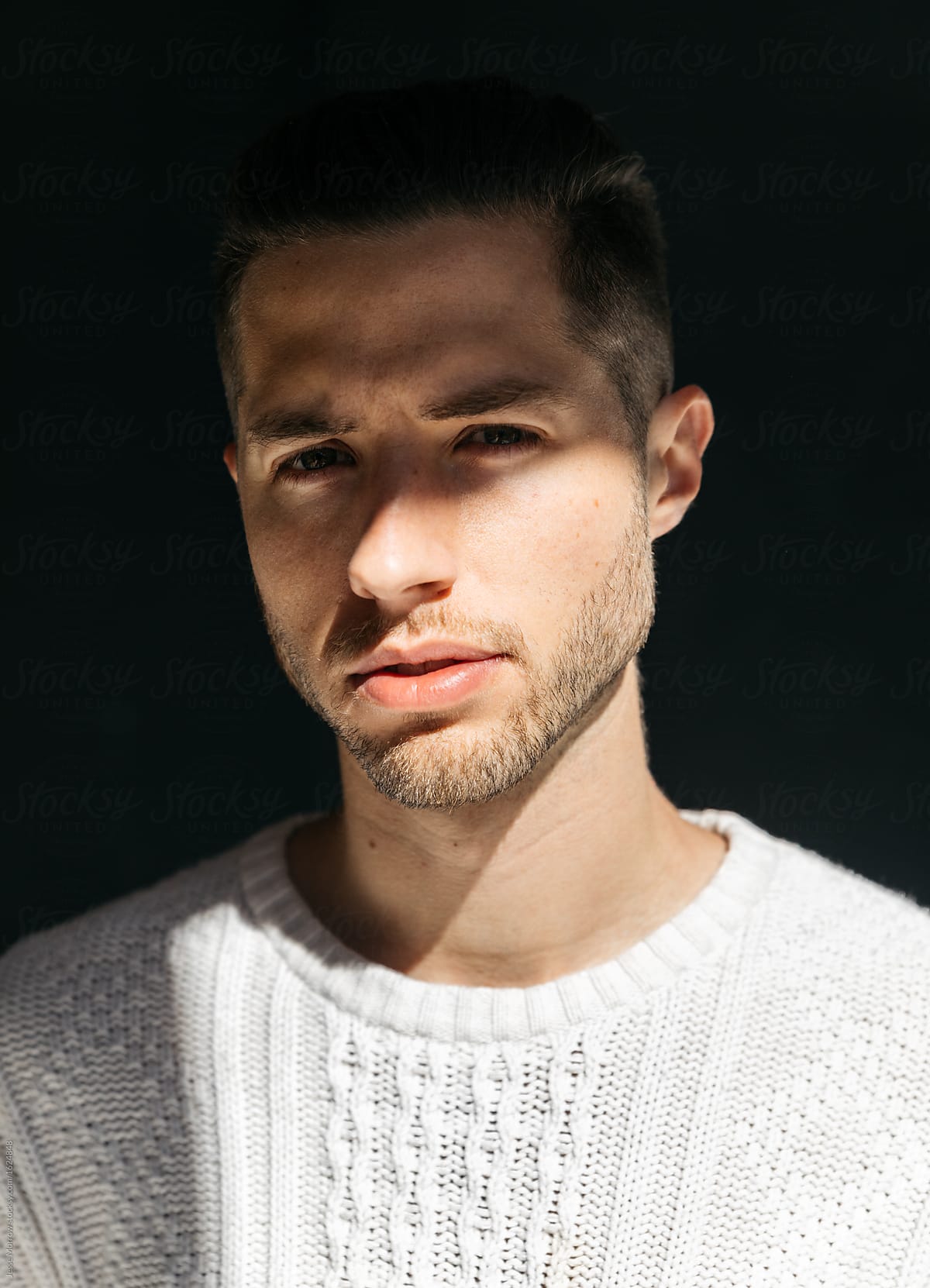Portrait Of Young Male With Strong Shadows On Face In Studio Contrast Portrait Of Young Male With Strong Shadows On Face In Studio Contrast