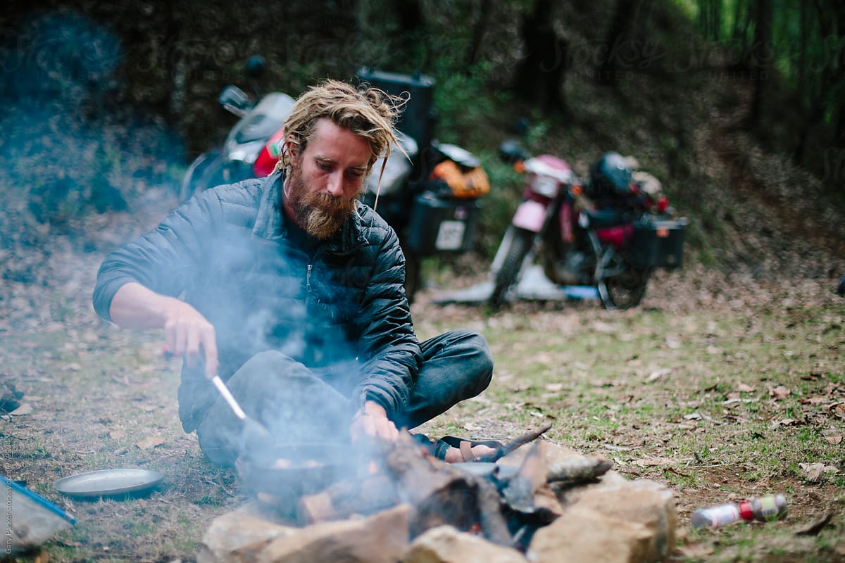 "A Man Cooking Over A Campfire" by Stocksy Contributor "Gary Parker ...
