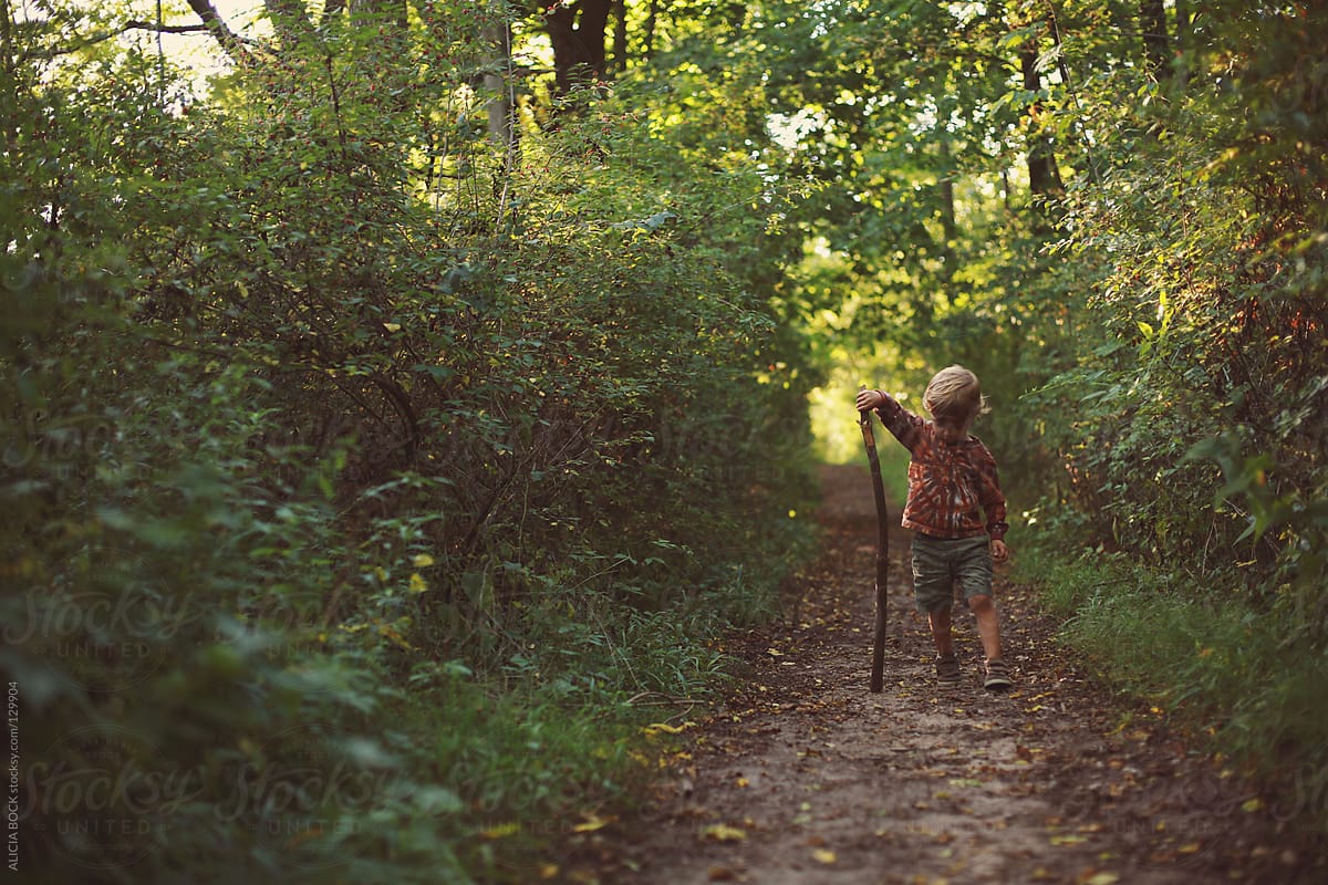 "Boy With A Stick #4" by Stocksy Contributor "ALICIA BOCK" - Stocksy