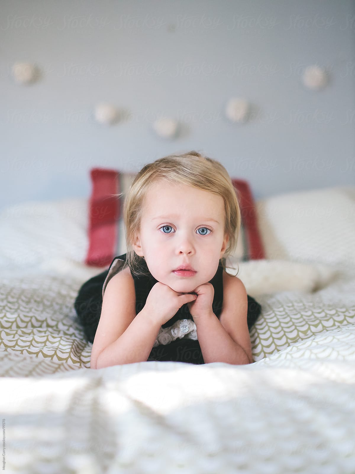  Little Girl Lying On A Bed In A Christmas Dress By Stocksy