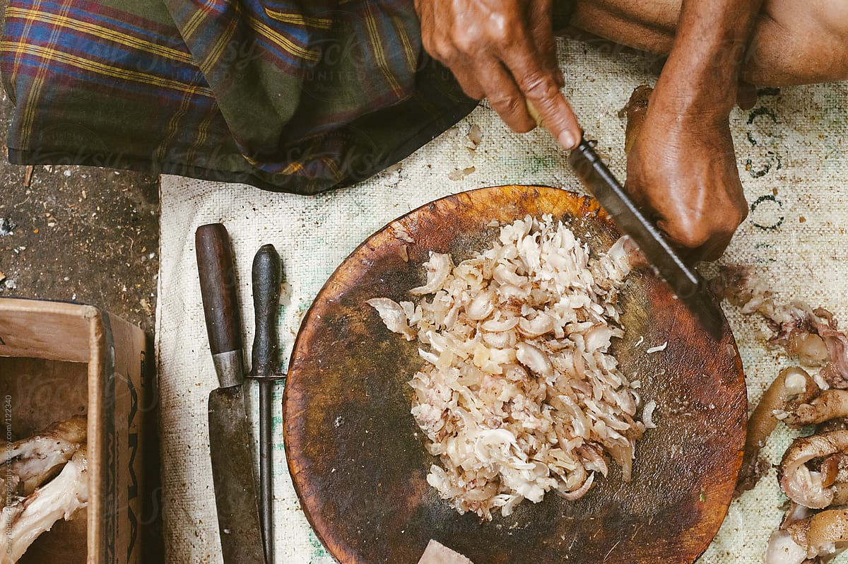 "Balinese Man Finely Chopping Cooked Pork" by Stocksy Contributor "Gary ...