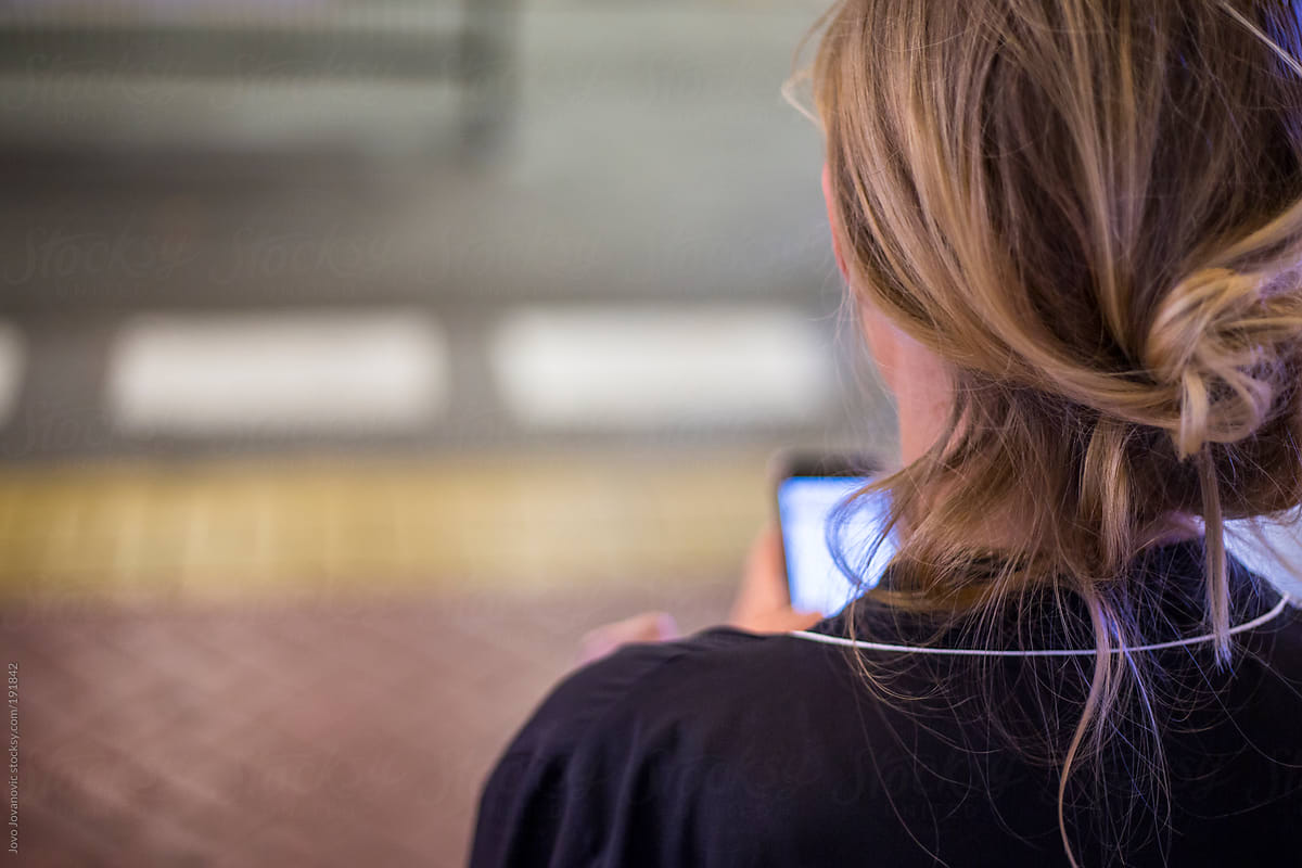 "Back View Of Blonde Woman Using Her Smart Phone" by Stocksy ...