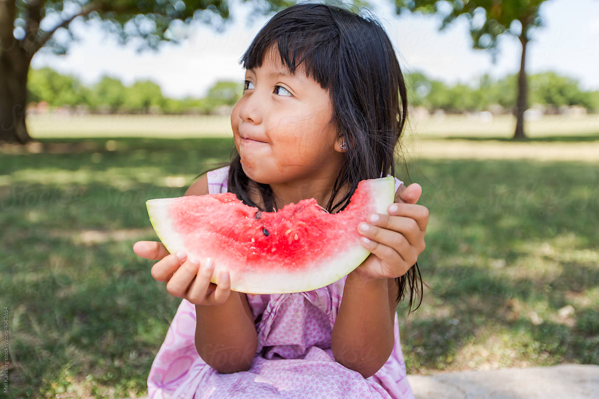 "Girl Sitting On Curb Eating A Watermelon" by Stocksy Contributor "Mel ...