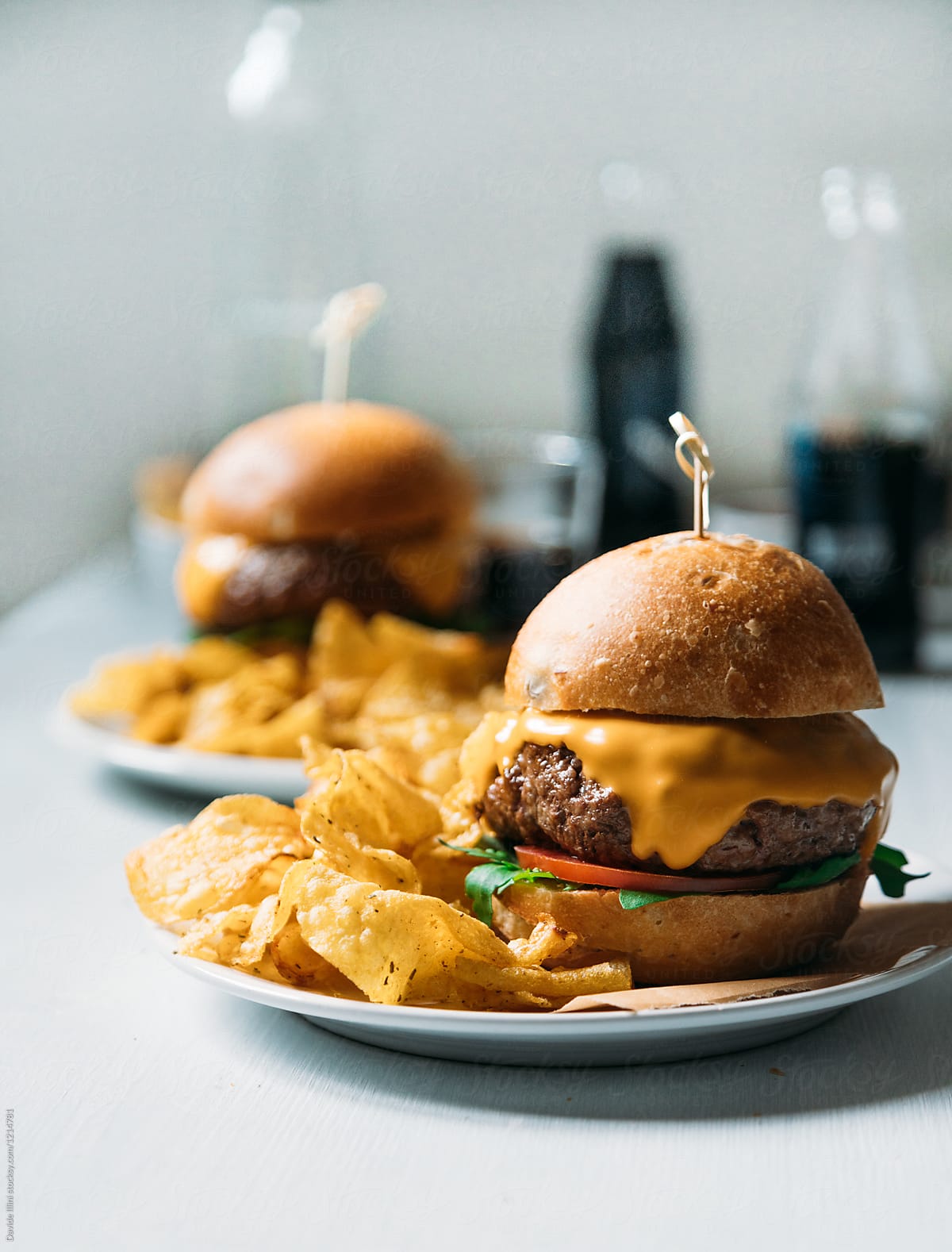 "Cheeseburger With Chips" by Stocksy Contributor "Davide Illini" - Stocksy