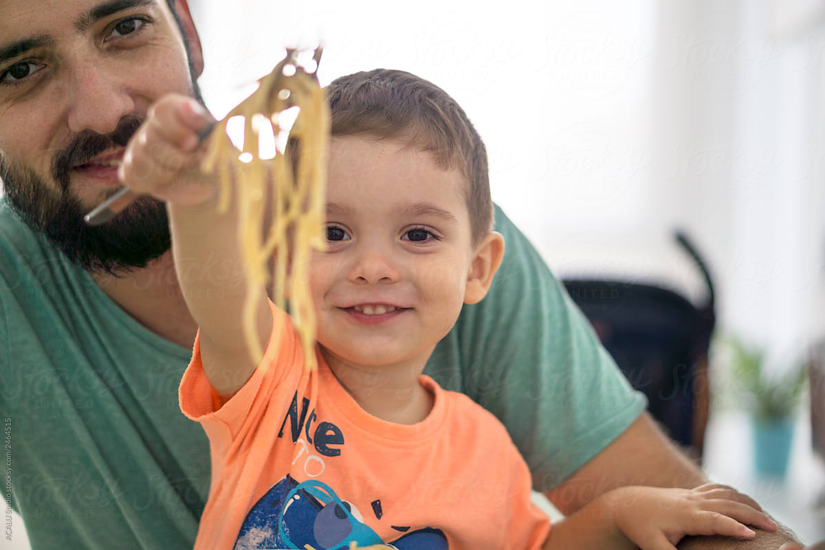 "Boy Eating Spaghetti With His Father" by Stocksy Contributor "ACALU ...