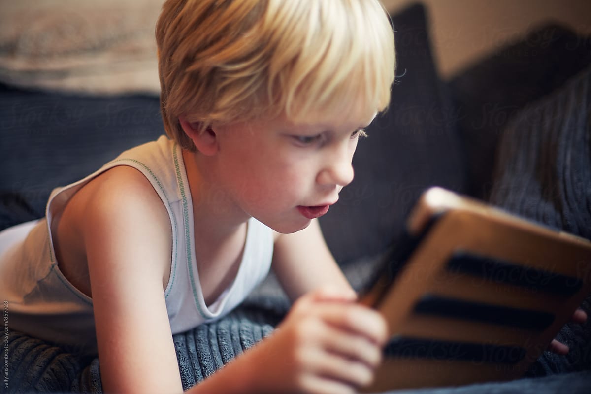 "Child Using A Digital Tablet" by Stocksy Contributor "Sally Anscombe ...