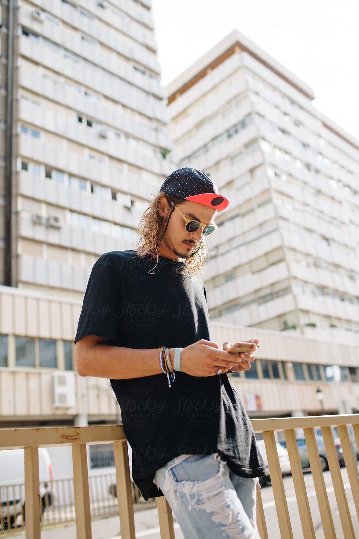 "Stylish Man Using Smartphone" by Stocksy Contributor "Javier Díez ...