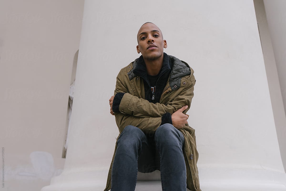 "Black Man Sitting On A Column." by Stocksy Contributor "Luis Velasco ...