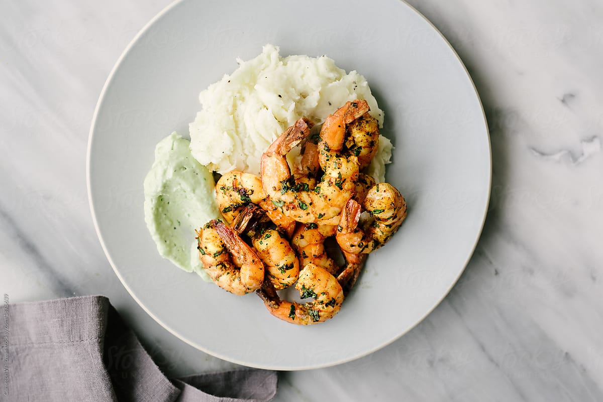 "Plate Of Spicy Shrimp, Avocado Aioli And Mashed Yucca" by Stocksy ...