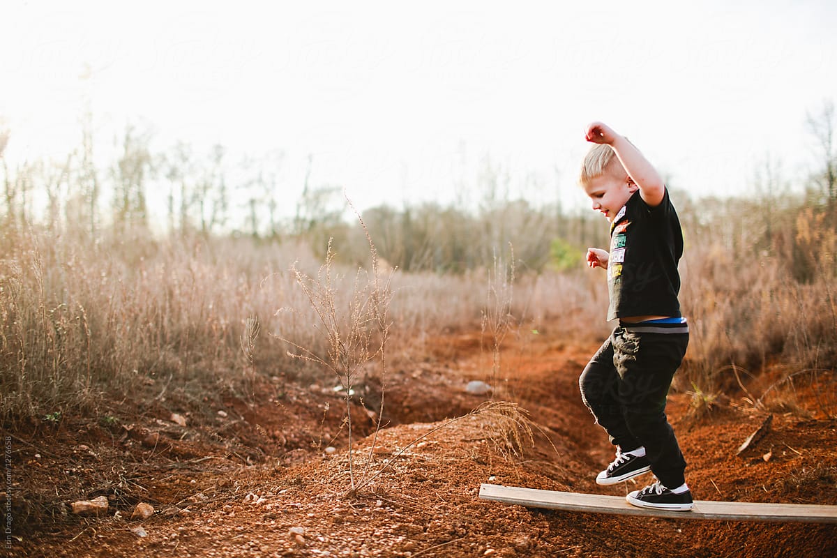 "Boy On Bridge" by Stocksy Contributor "Erin Drago" - Stocksy