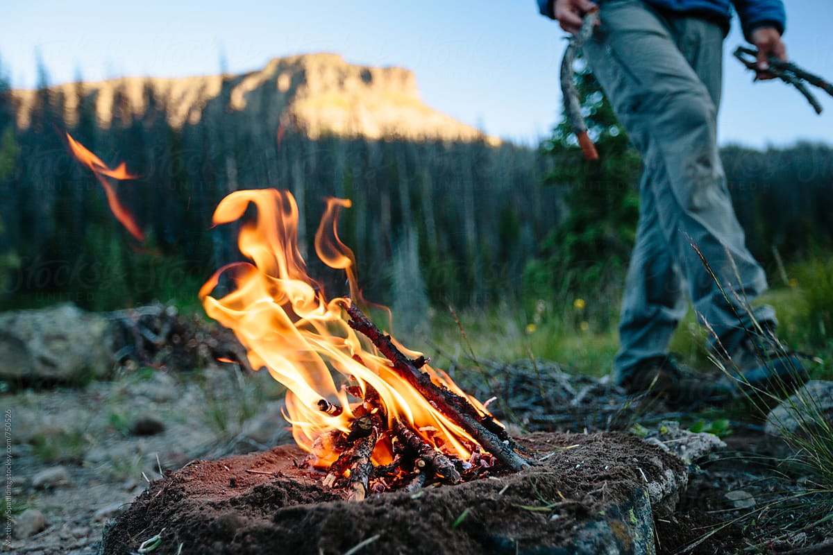"Man Creating Low Impact Fire Outdoors" by Stocksy Contributor "Matthew ...