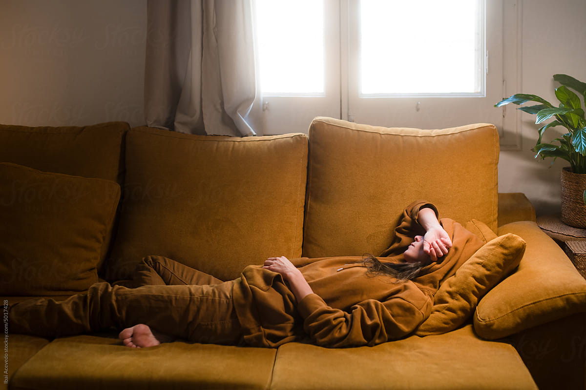 "Tired Woman Merging With The Sofa" by Stocksy Contributor "Ibai ...