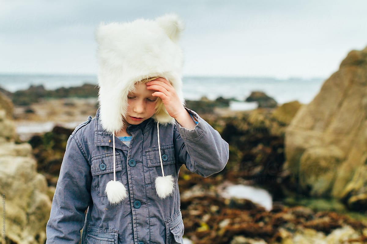 "Contemplative Child Walking On Rocky Shore" by Stocksy Contributor ...