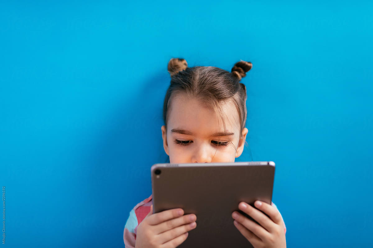 "Cute Girl Using A Tablet" by Stocksy Contributor "Mihajlo Ckovric ...