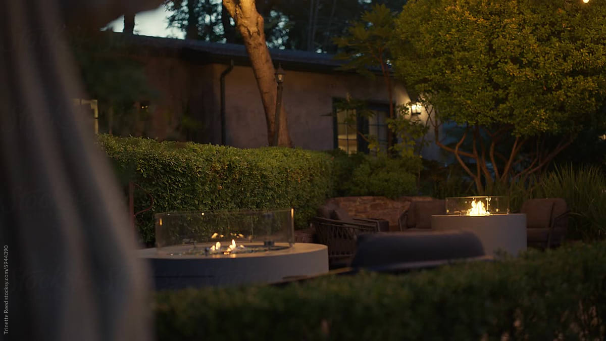 "Outdoor Lounge Area With Fire Pits At Hotel At Night" by Stocksy ...