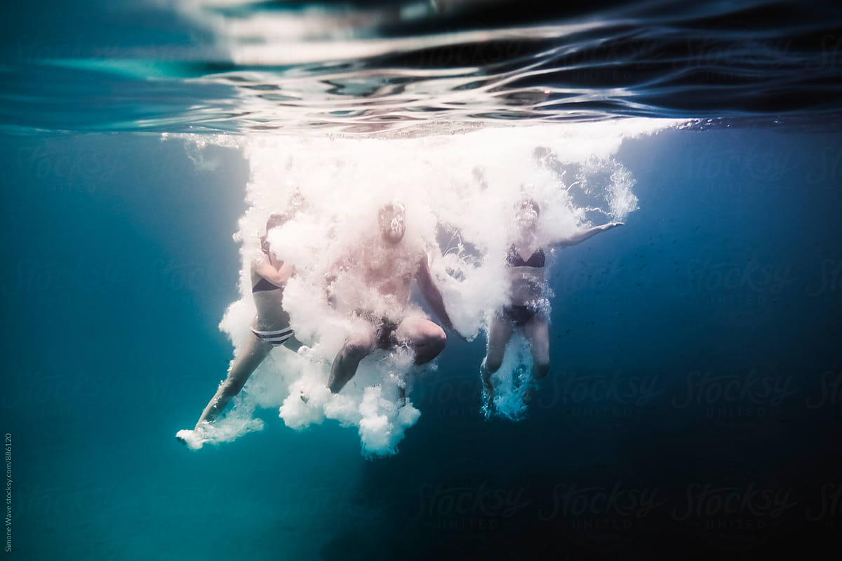 "Friends Diving" by Stocksy Contributor "Koganami Studio" - Stocksy