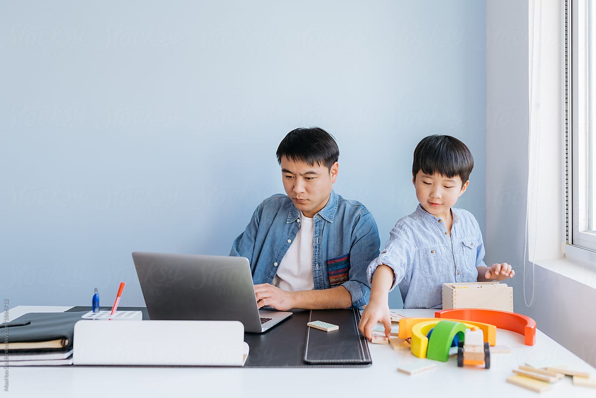 "Father Working At Home" by Stocksy Contributor "MaaHoo" - Stocksy