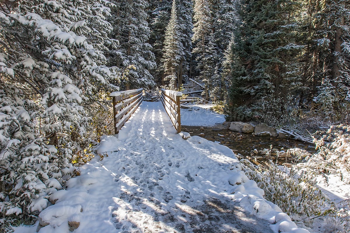 "Snow Covered Foot Bridge" by Stocksy Contributor "Adam Nixon" - Stocksy