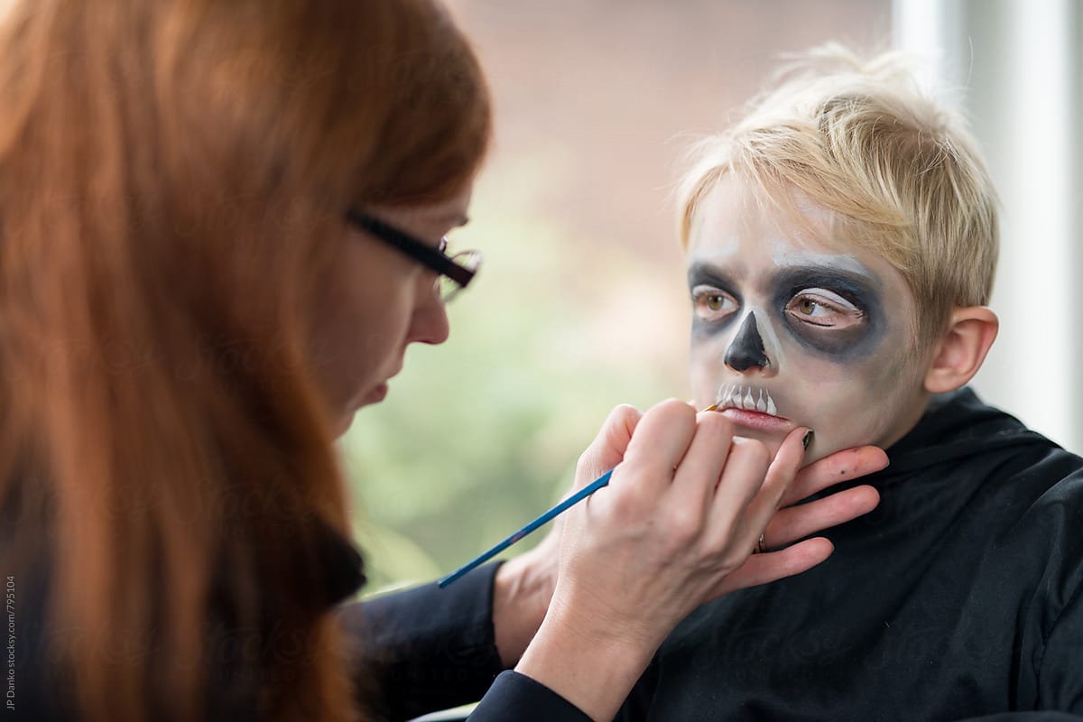 "Mother Applying Little Boys Halloween Costume Make Up" by Stocksy ...