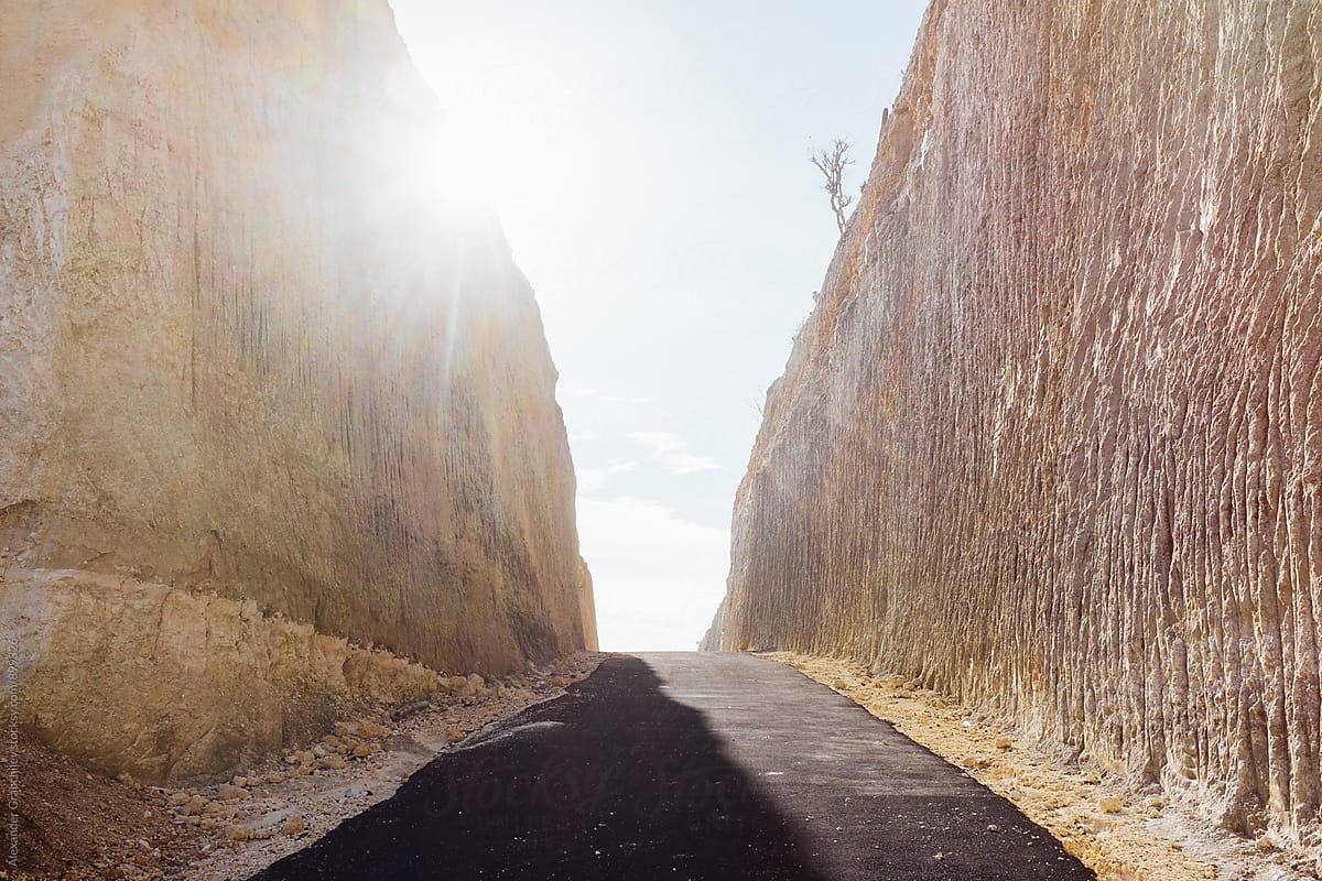 "Sunlit Road Between Limestone Cliffs" by Stocksy Contributor "Eugenia ...