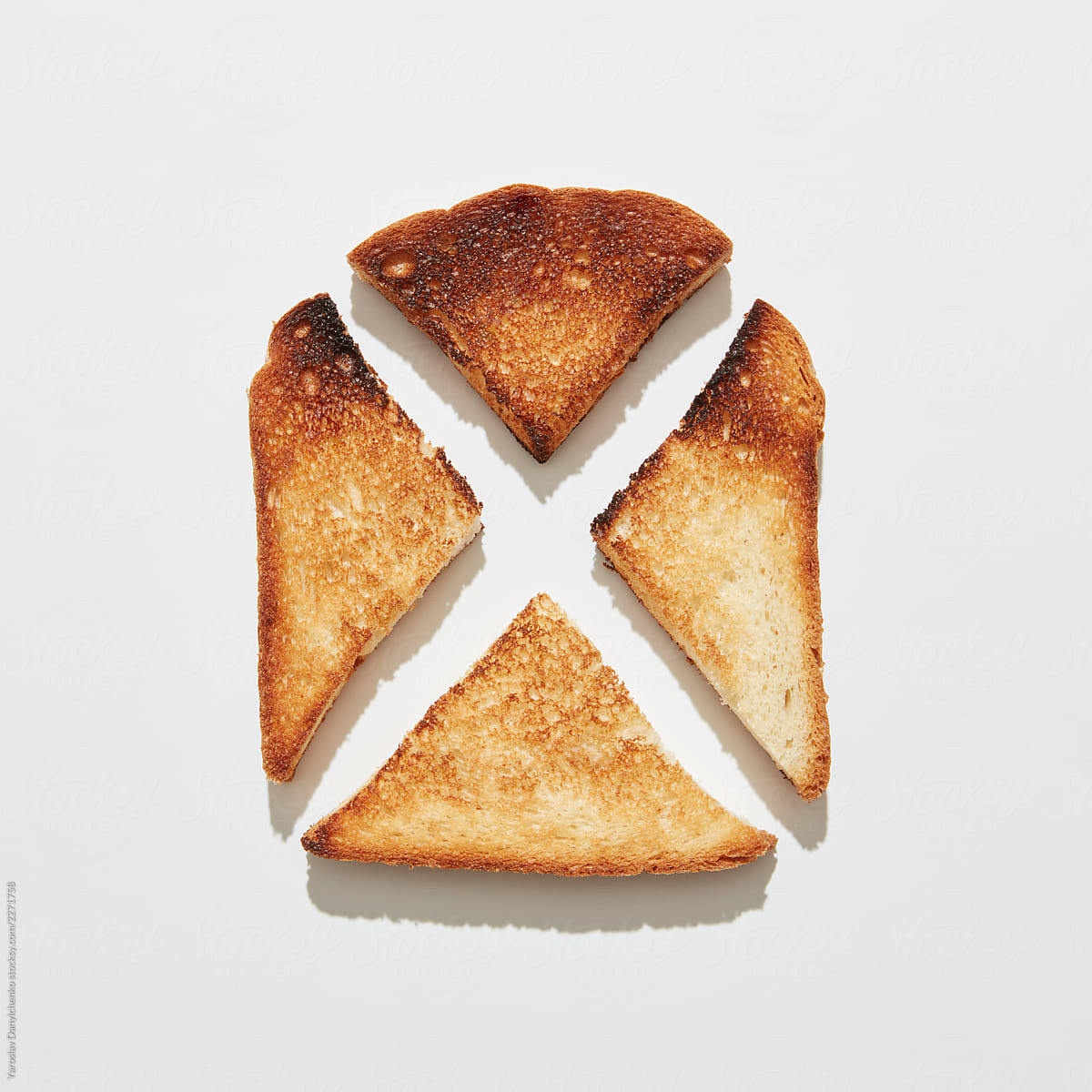 "Four Triangular Pieces Of Fried Toast On White Background" by Stocksy ...