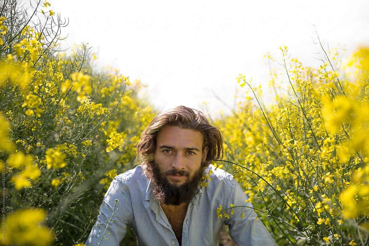 "Portrait Of A Man Sitting In A Field" by Stocksy Contributor "Bowery ...