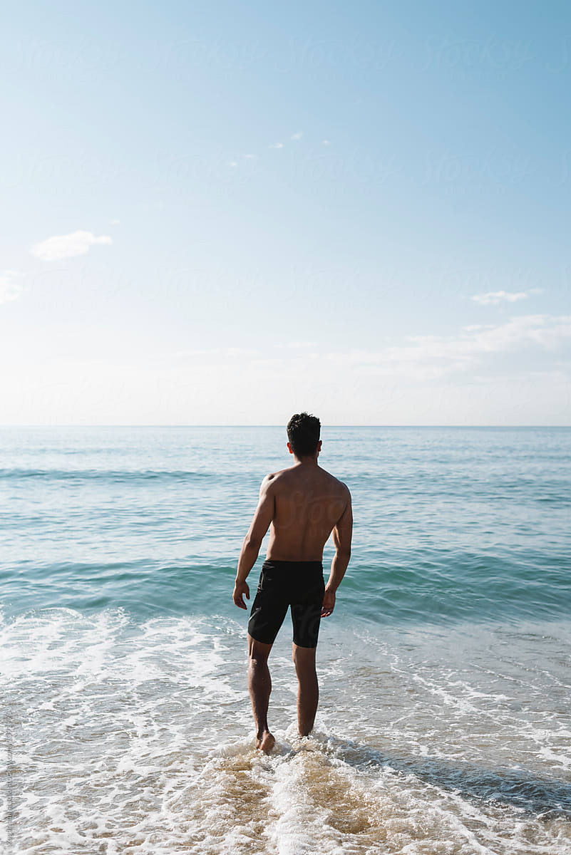 "Young Man Standing Against The Sea" by Stocksy Contributor "koganami ...