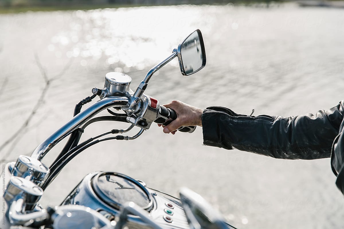 "Hand On Motorcycle" by Stocksy Contributor "Raymond Forbes LLC" - Stocksy