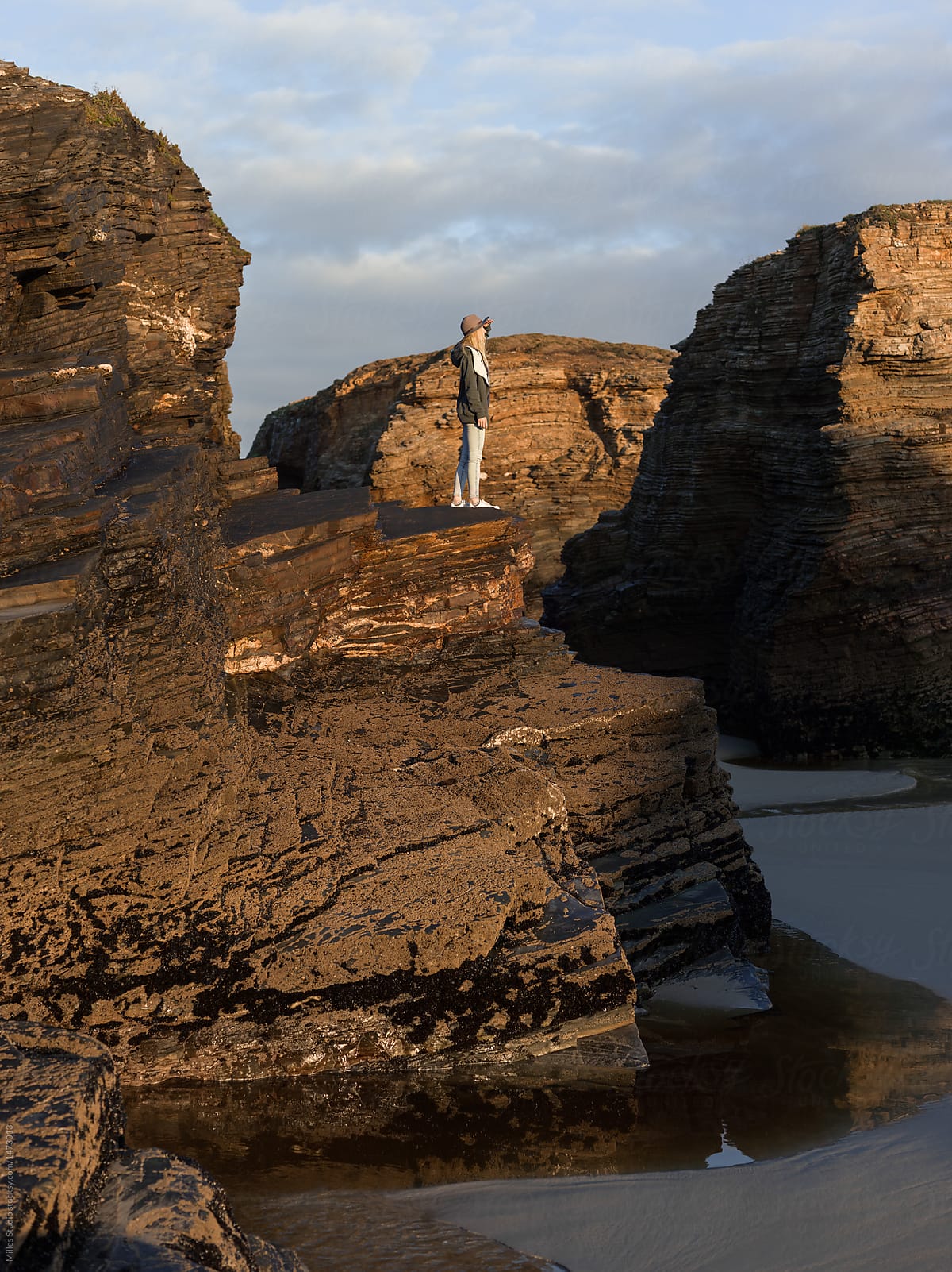 "Woman Standing On Beach Rock" by Stocksy Contributor "Milles Team ...