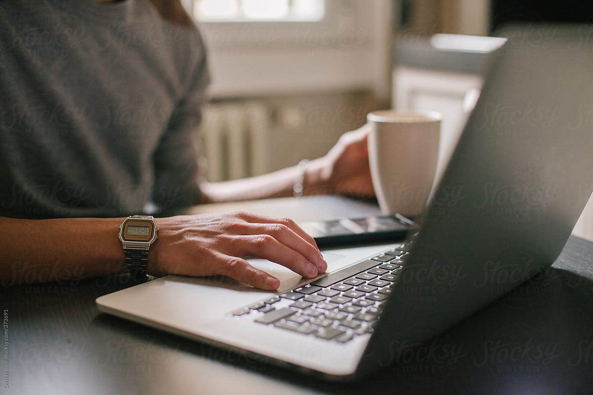 "Young Man Using Laptop" by Stocksy Contributor "Davide Illini" - Stocksy