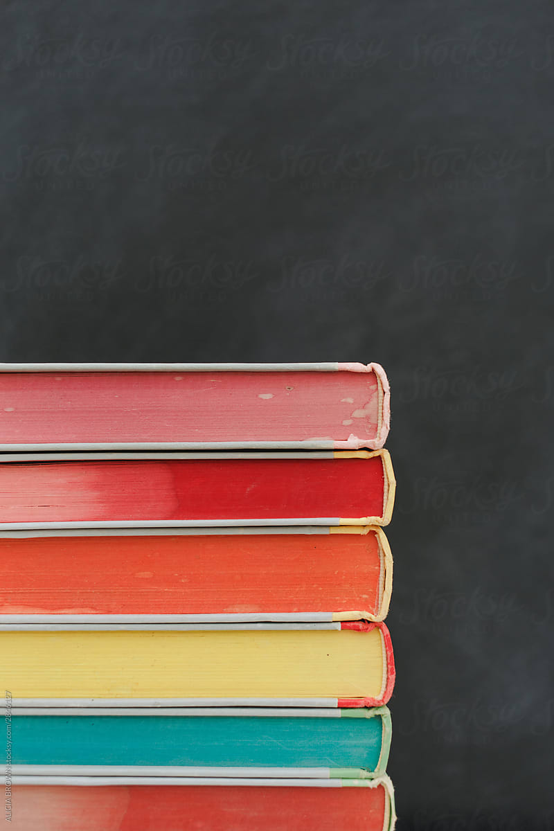 "Pile Of Rainbow Books" by Stocksy Contributor "ALICIA BROWN" - Stocksy