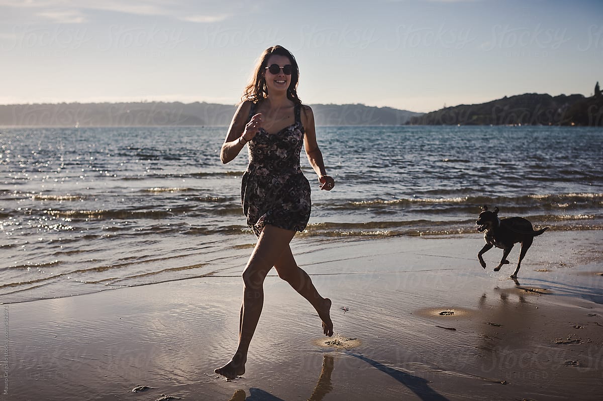 "Woman Runs And The Dog Chases Her" by Stocksy Contributor "Mauro ...