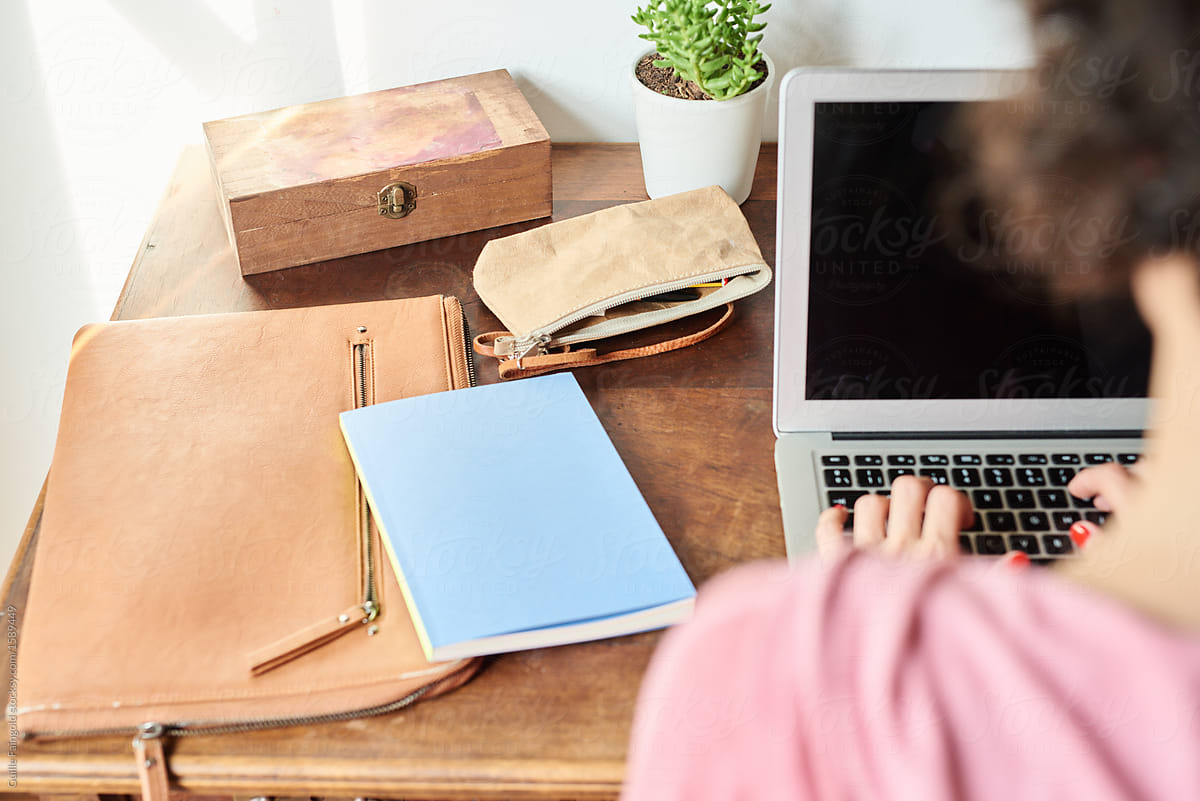 "Woman Typing At Wooden Desk" by Stocksy Contributor "Guille Faingold ...