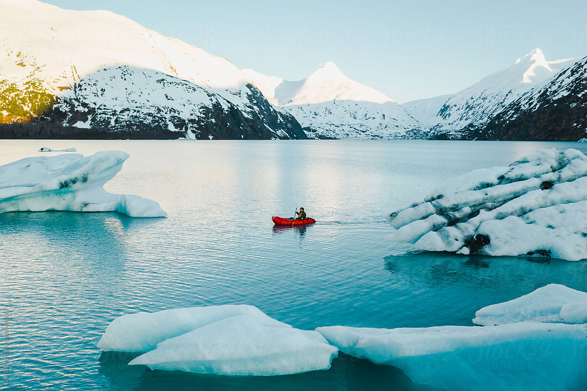 "Man Packrafts Around Glacier Ice In Red Raft In Alaska" by Stocksy ...