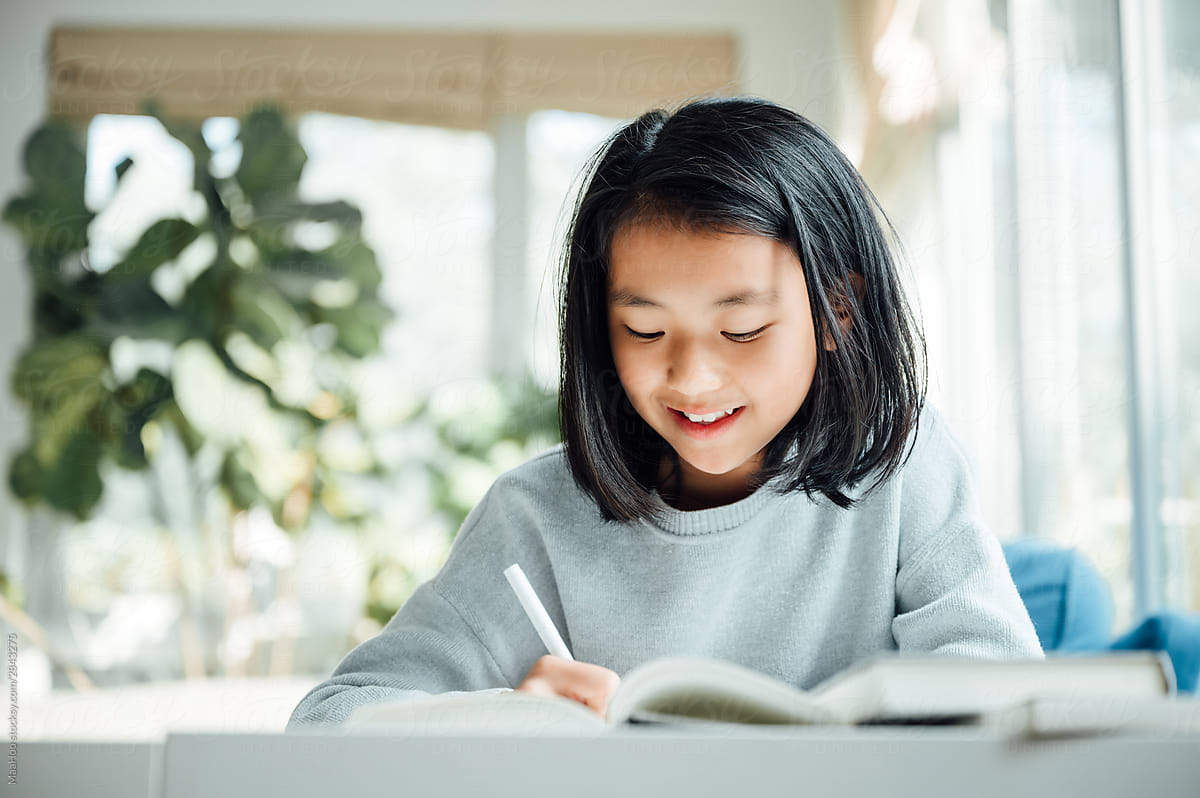 "Cute Girl Studying At Home" by Stocksy Contributor "MaaHoo" - Stocksy
